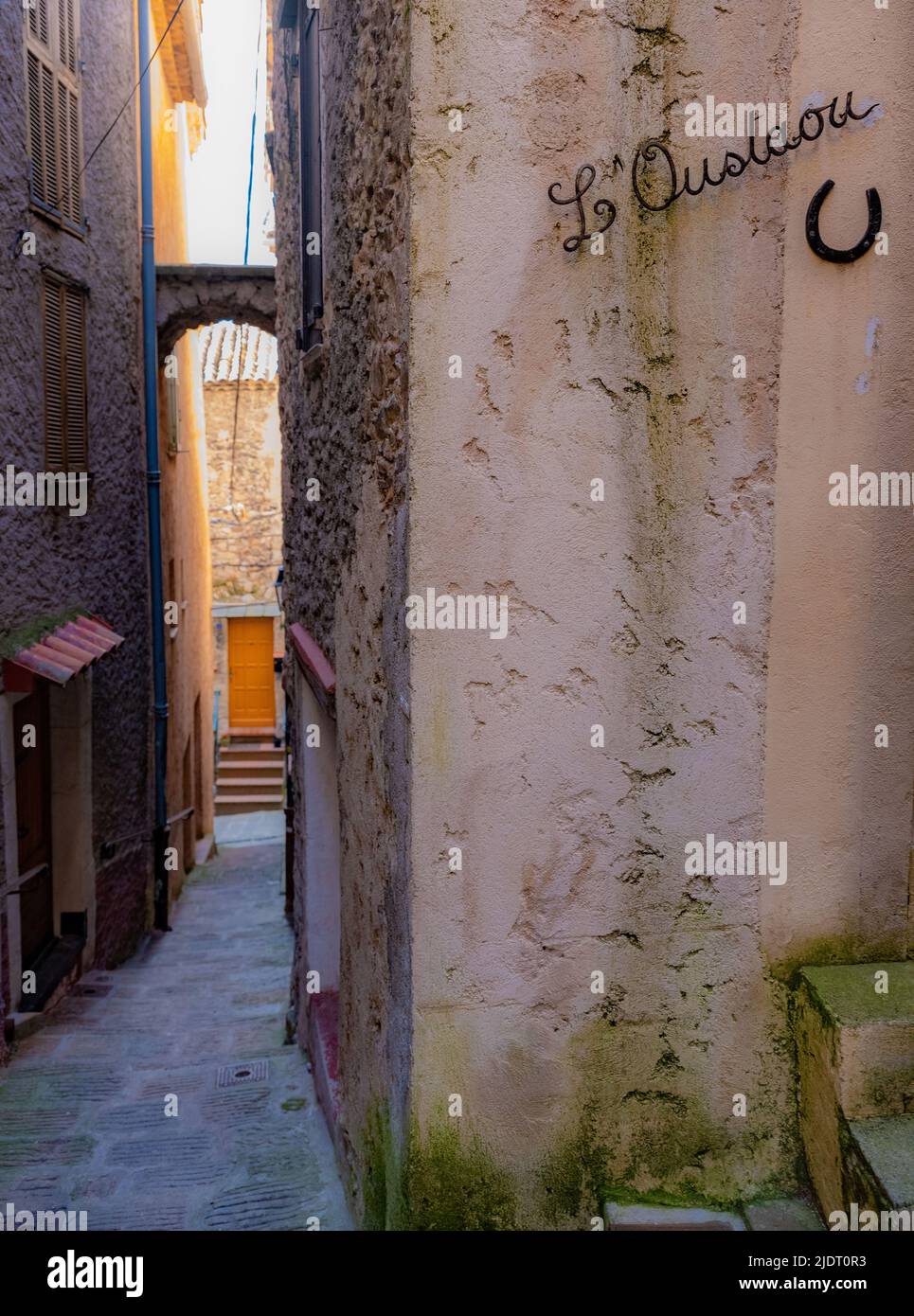 Arched passage way through the medieval streets of the Provençal ...