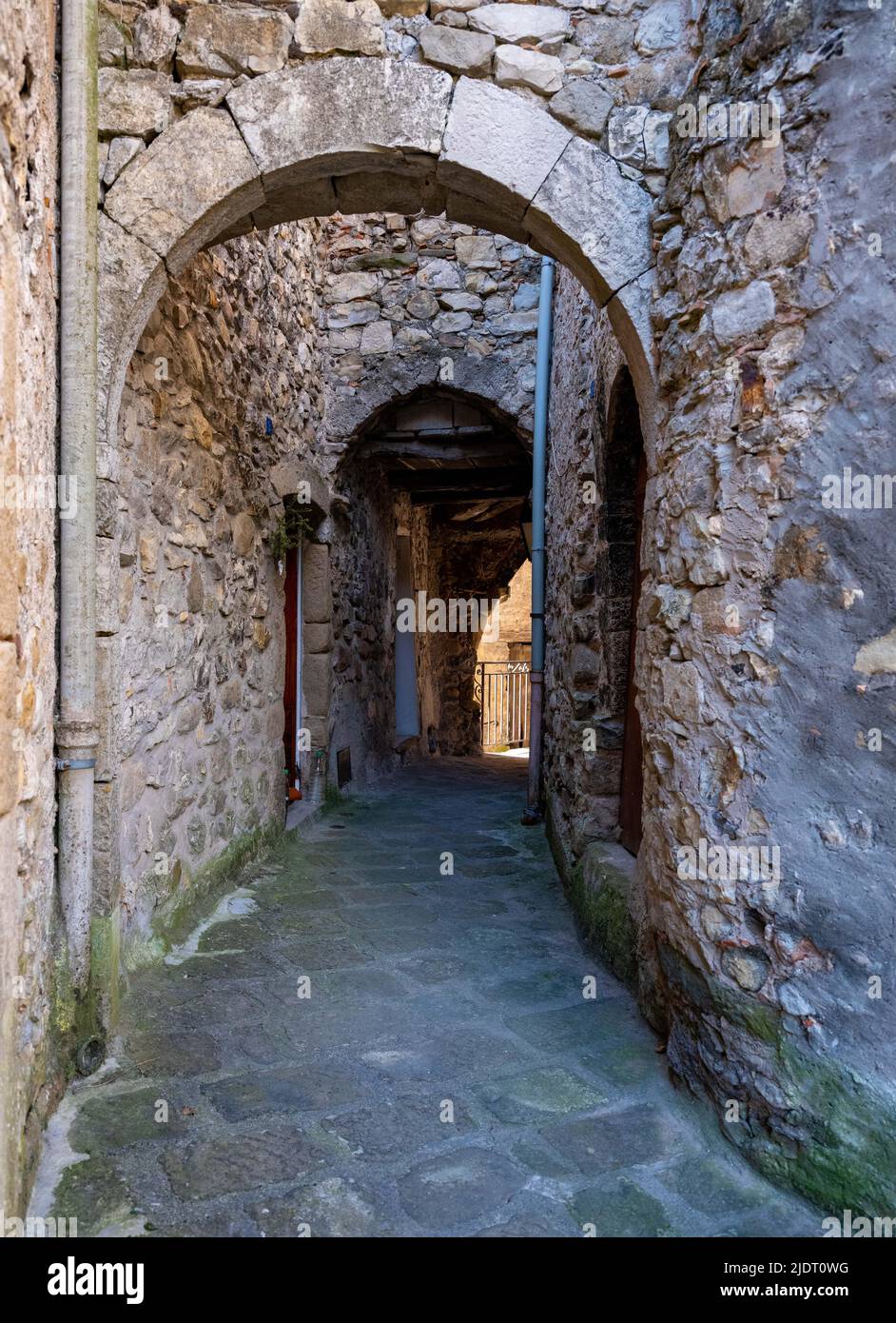 Arched passage way through the medieval streets of the Provençal ...