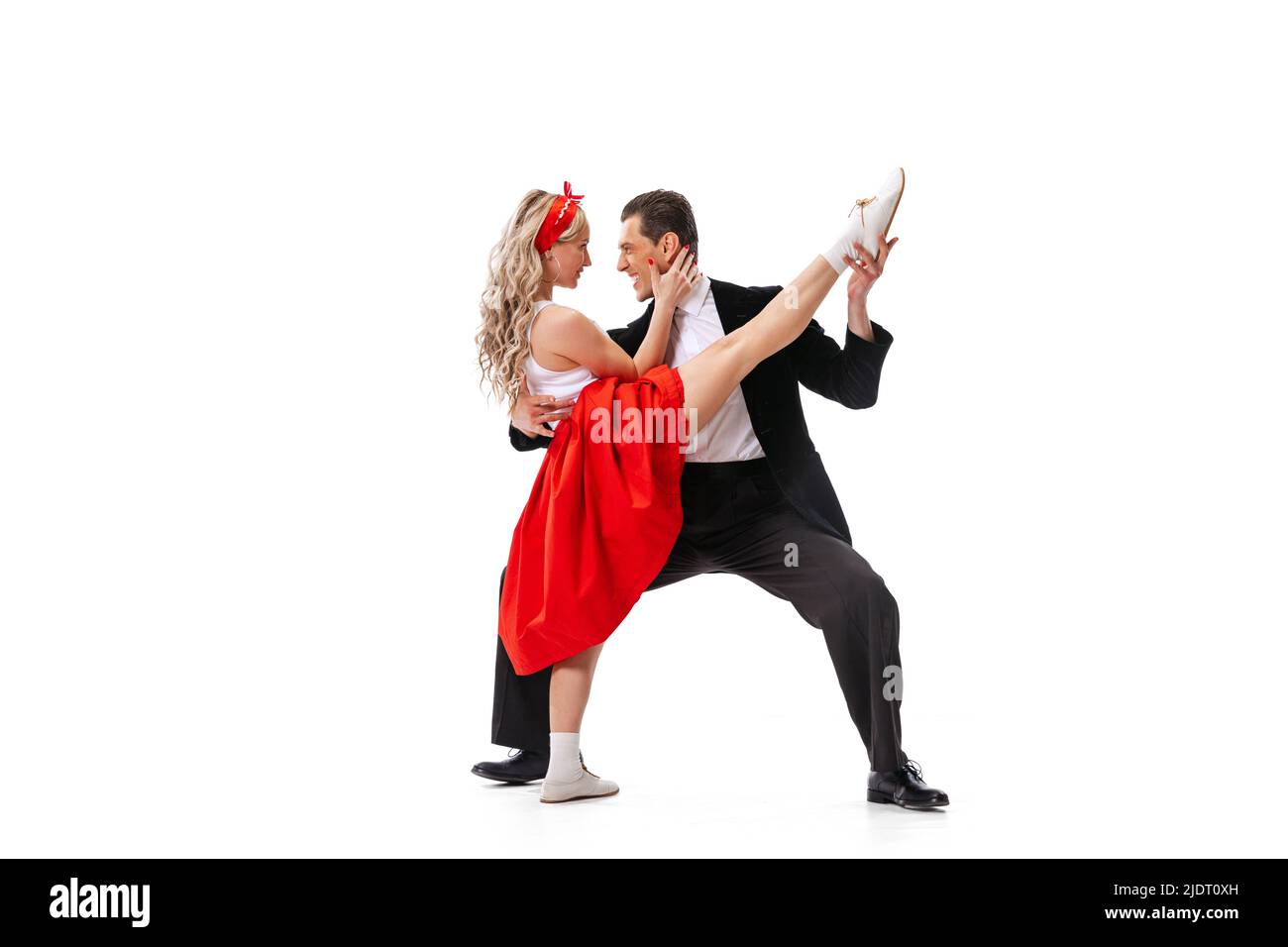 Excited young couple of dancers in vintage retro style outfits dancing ...