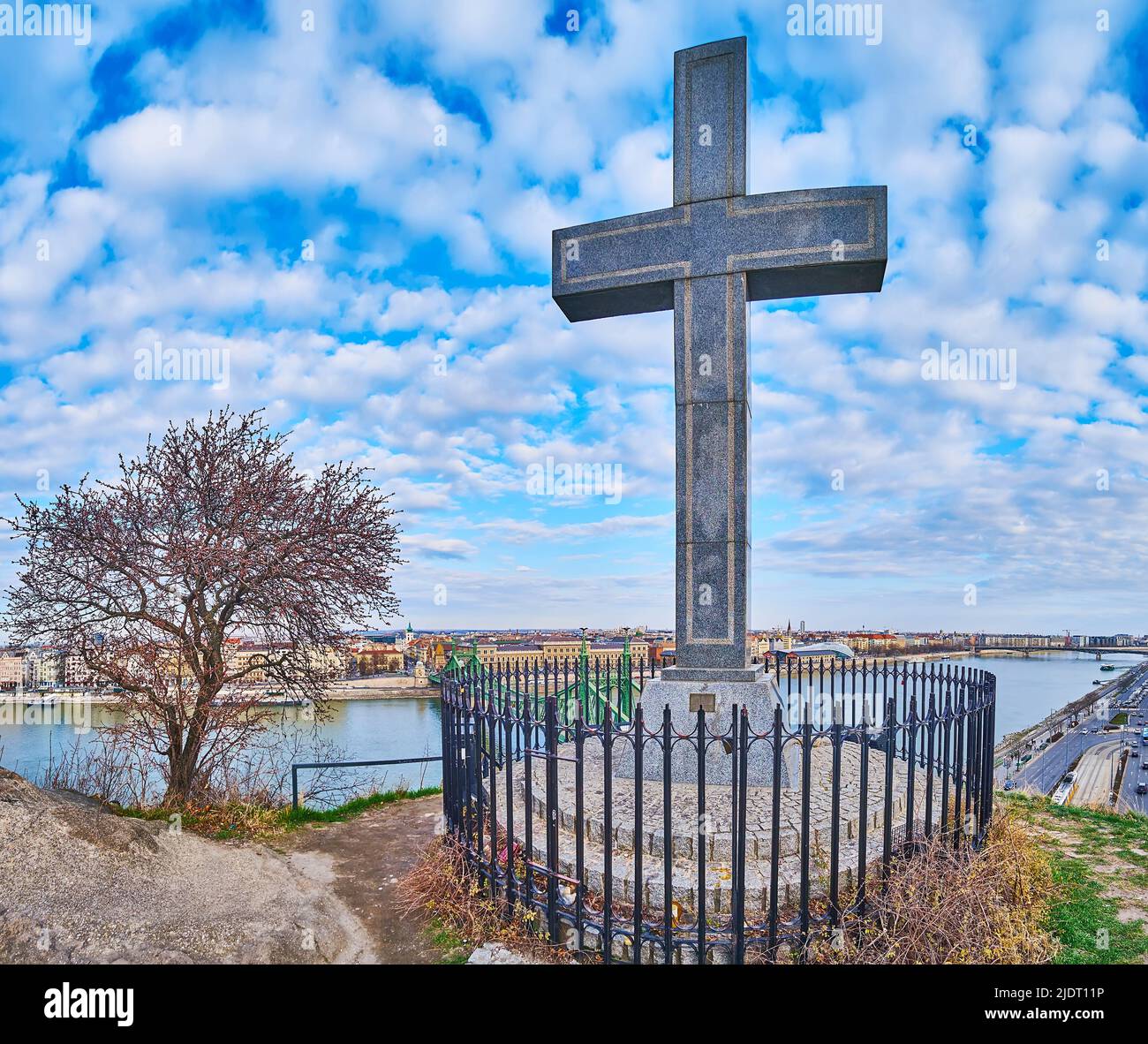 The stone Cross on the Gellert Hill against the bright blue sky ...