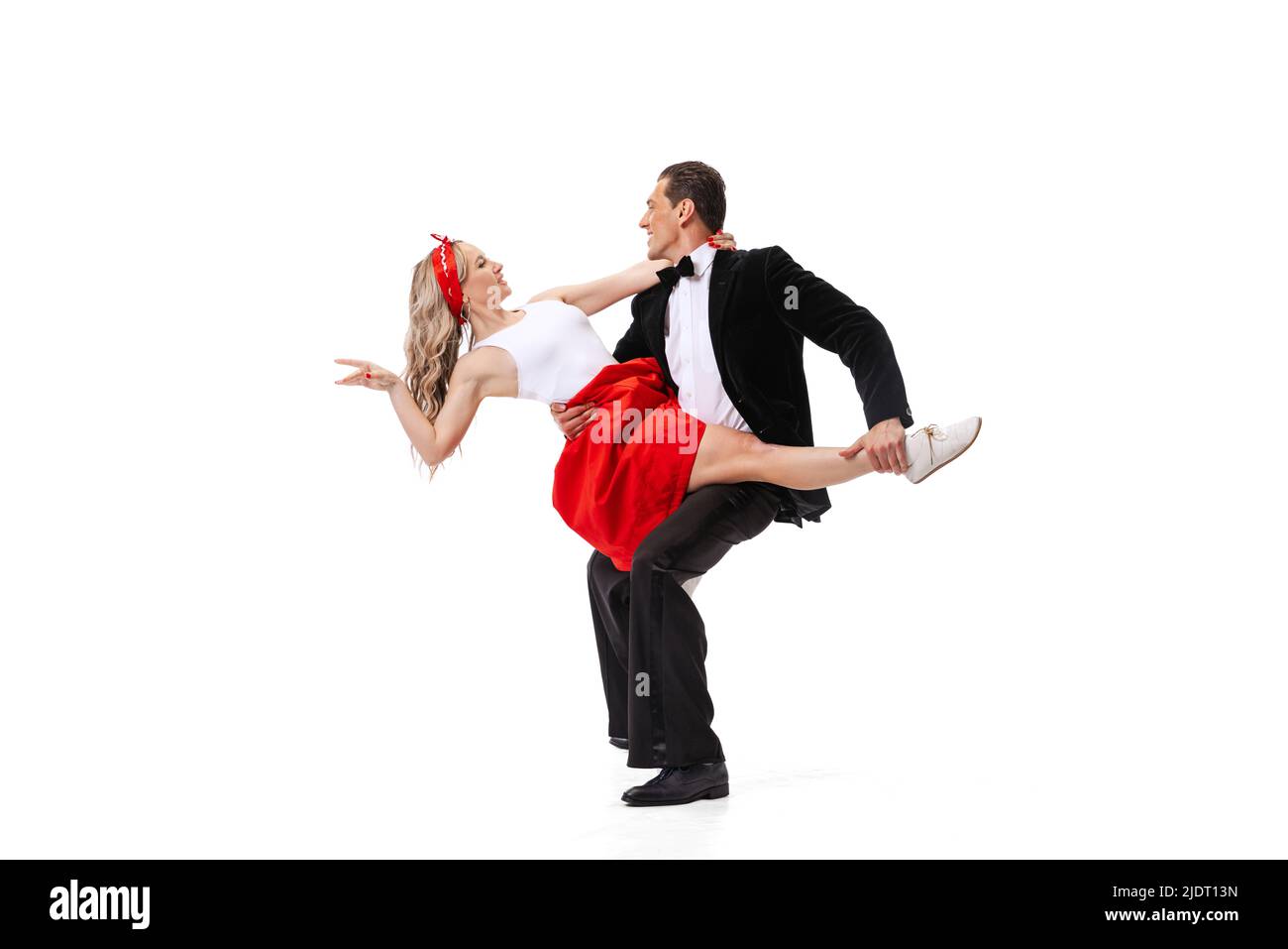 Excited young couple of dancers in vintage retro style outfits dancing ...