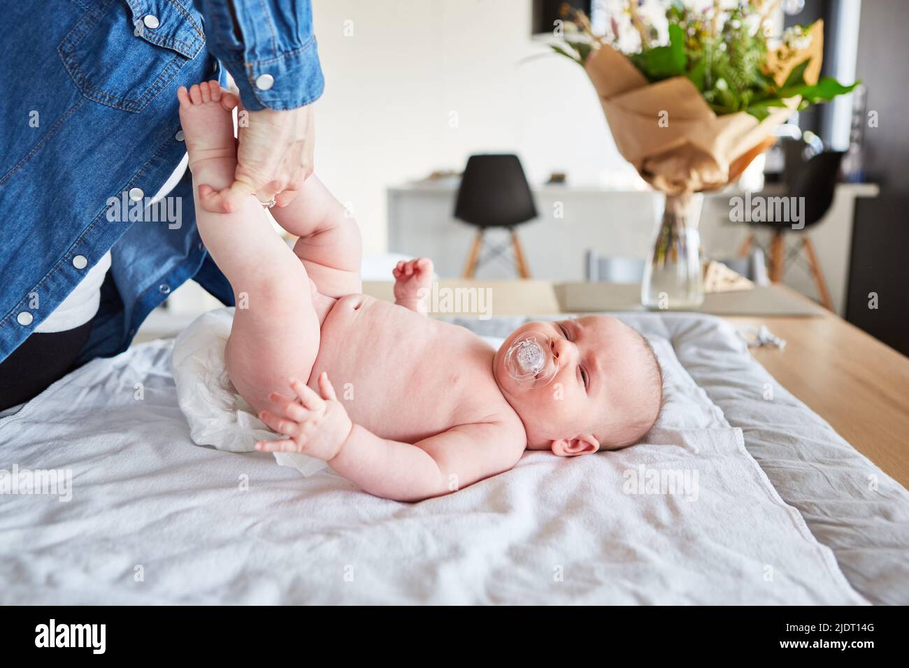 Mother changing babys diaper on hi-res stock photography and images - Alamy