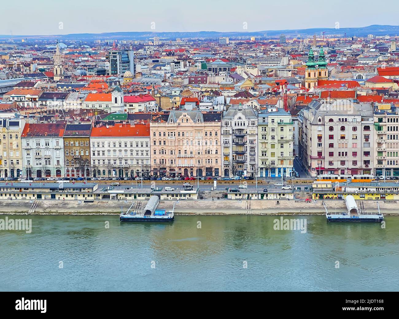 The Also Pesti Embankment with line of historic buildings and red roofs ...
