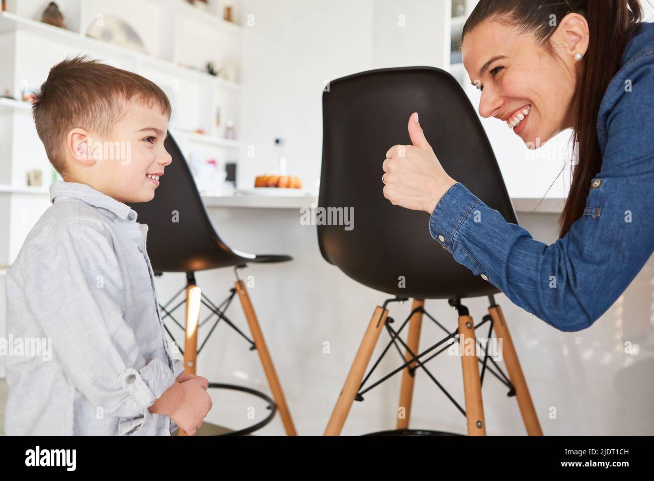 Mom shows thumbs up to her little son as praise and support Stock Photo ...