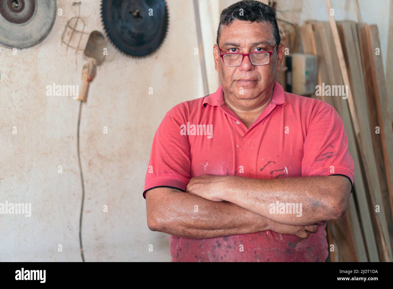 Latin carpenter posing at his workshop with his arms crossed Stock ...
