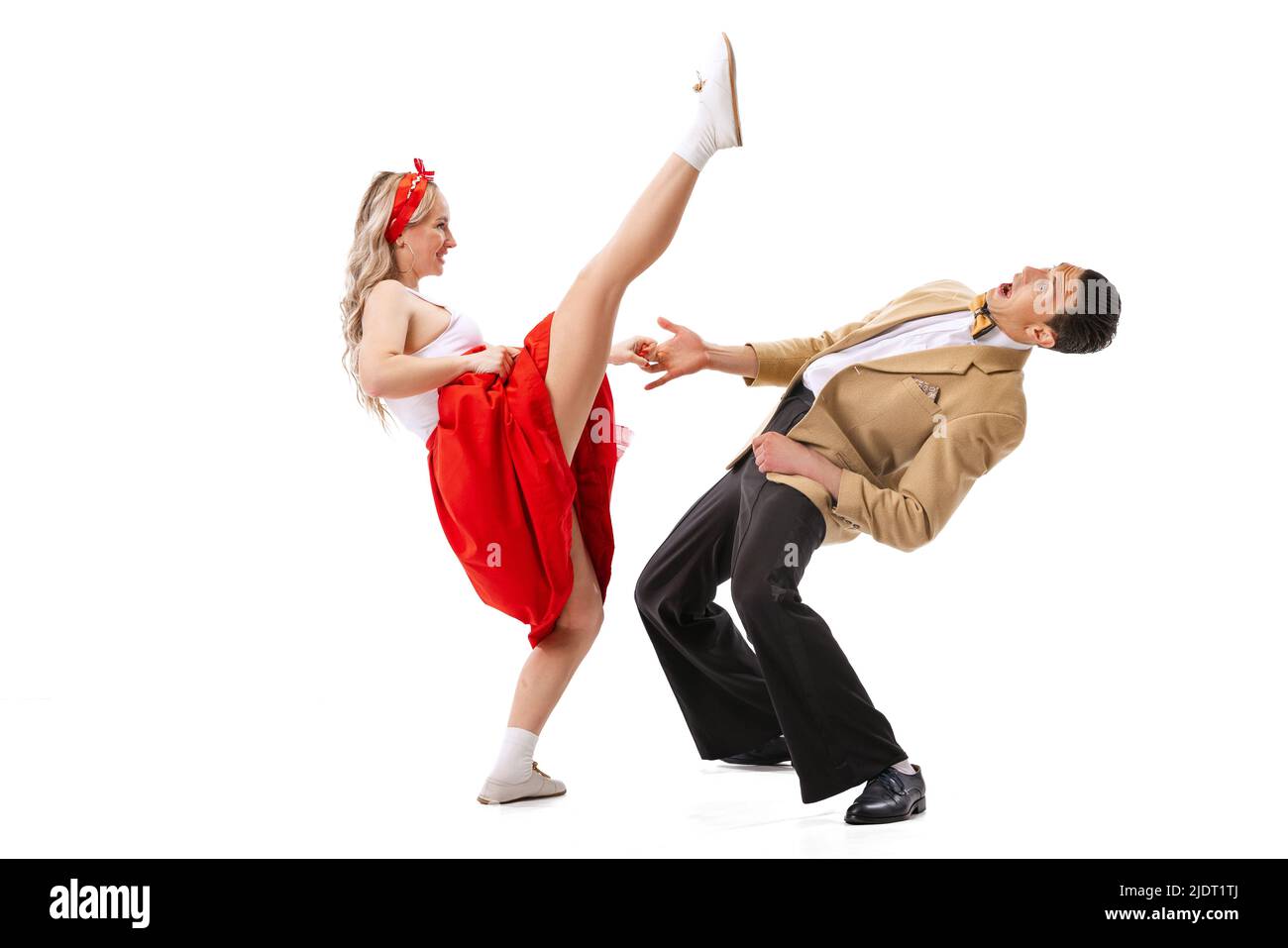 Excited young couple of dancers in vintage retro style outfits dancing ...