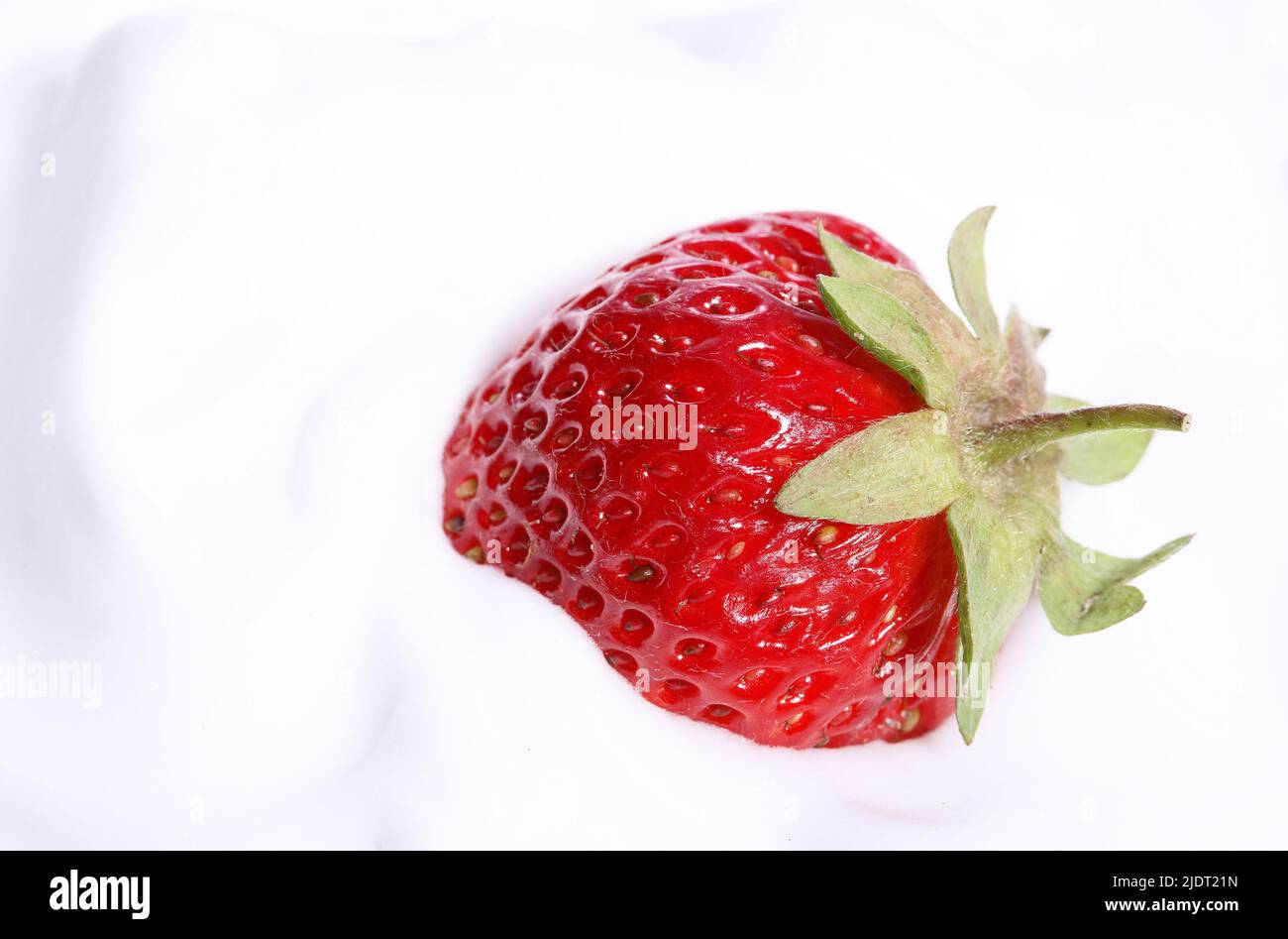 Strawberry in the cream: seasonal fruit to taste Stock Photo - Alamy
