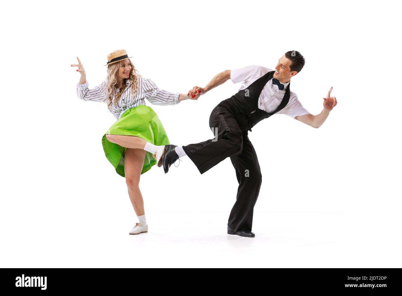 Excited young couple of dancers in vintage retro style outfits dancing ...