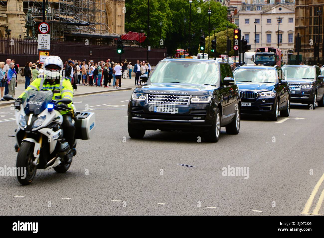 A convoy of ministerial cars and security with a police escort ...