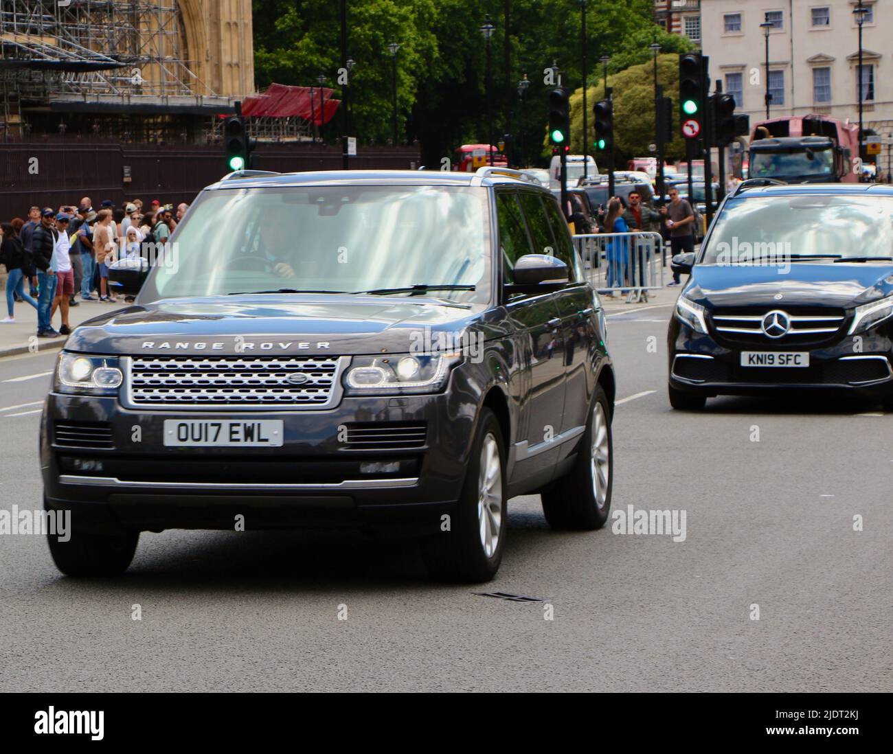A convoy of ministerial cars and security with a police escort ...
