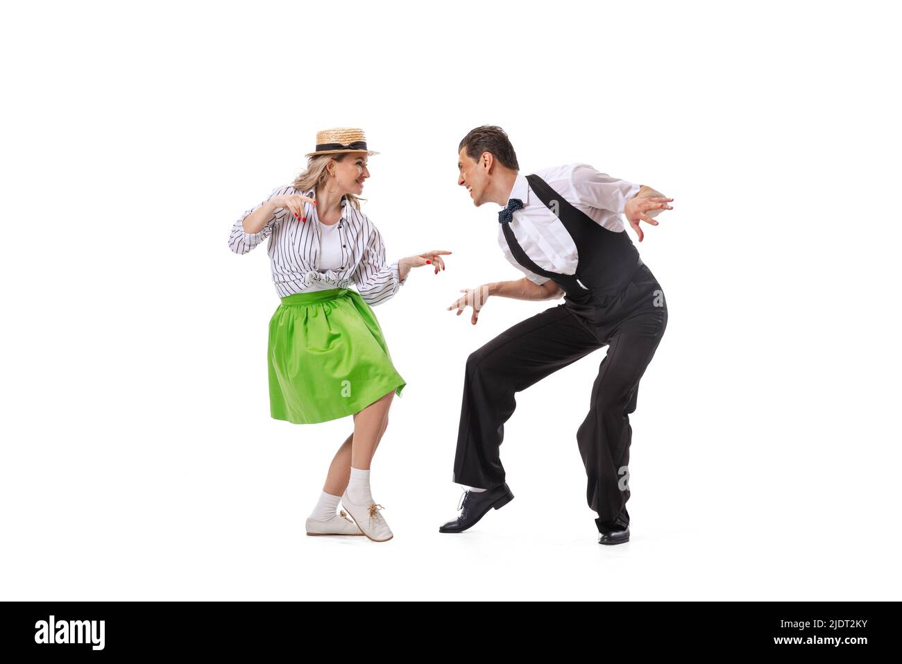 Excited young couple of dancers in vintage retro style outfits dancing ...