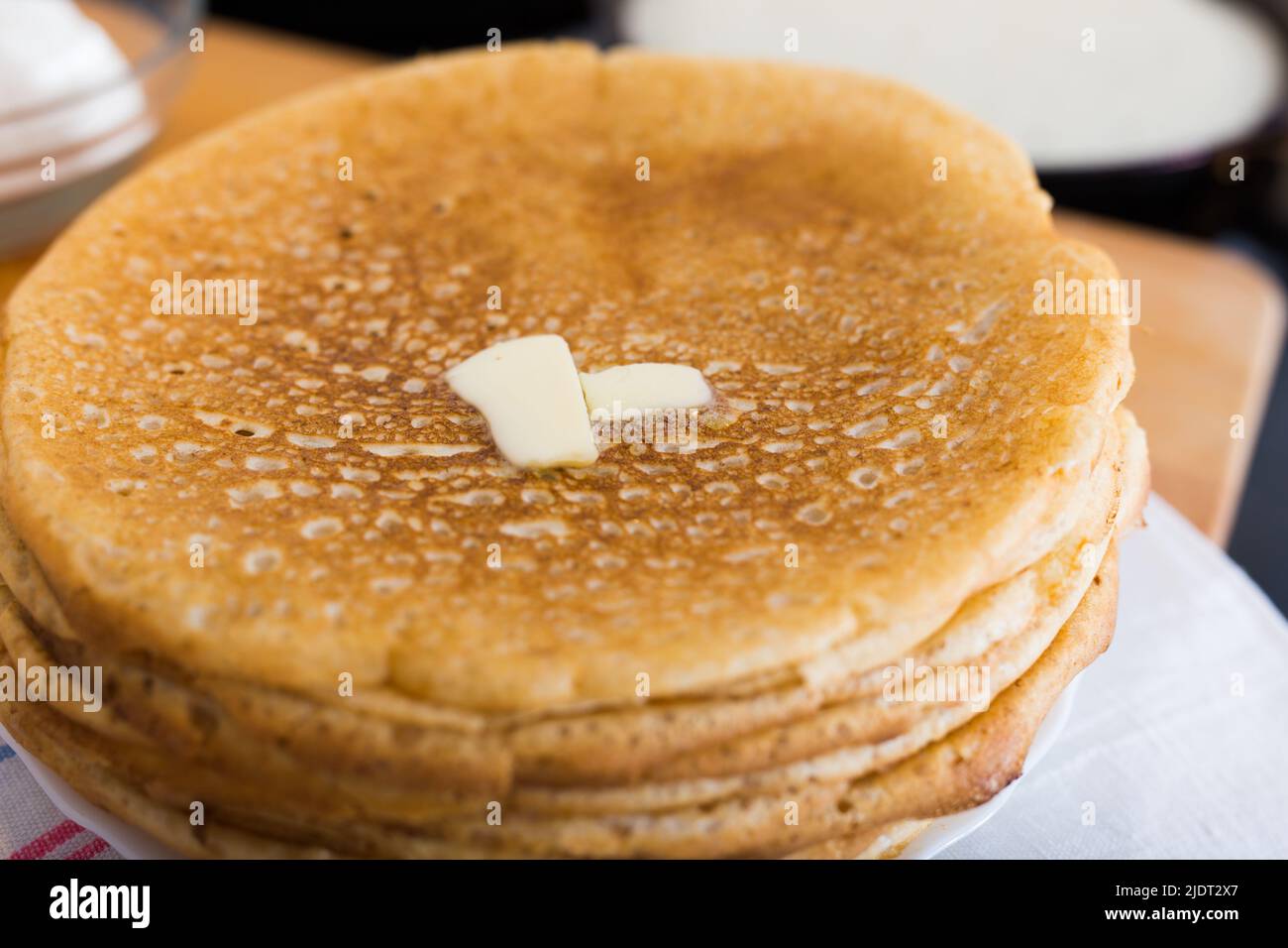 process of baking pancakes in pans on kitchen stove. stack of hot ...
