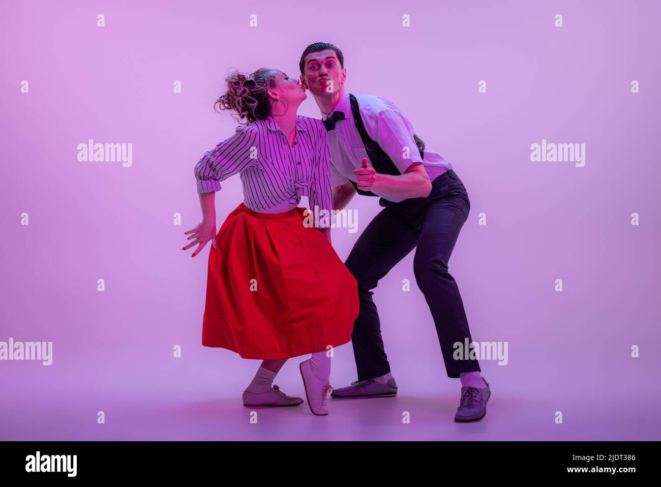 Stylish young man and pretty woman in vintage style outfits dancing ...