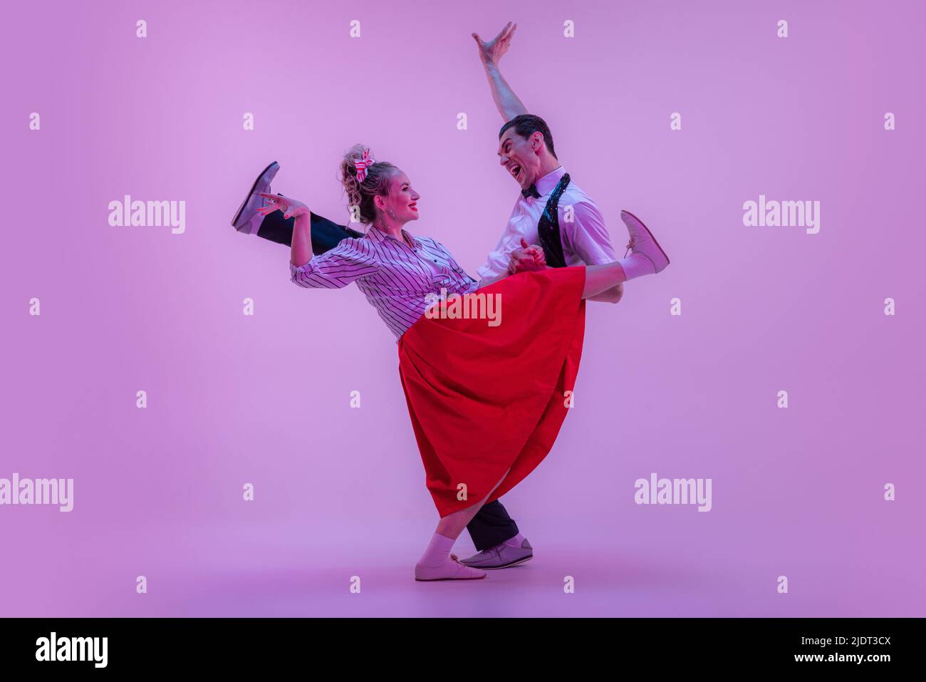 Stylish young man and pretty woman in vintage style outfits dancing ...