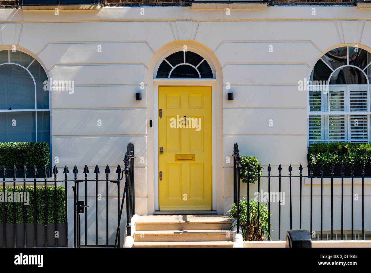 London- Yellow door on upmarket white stucco London townhouse in ...