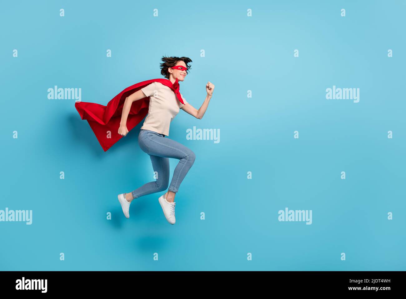 Full length photo of cute excited lady dressed red mantle jumping high ...