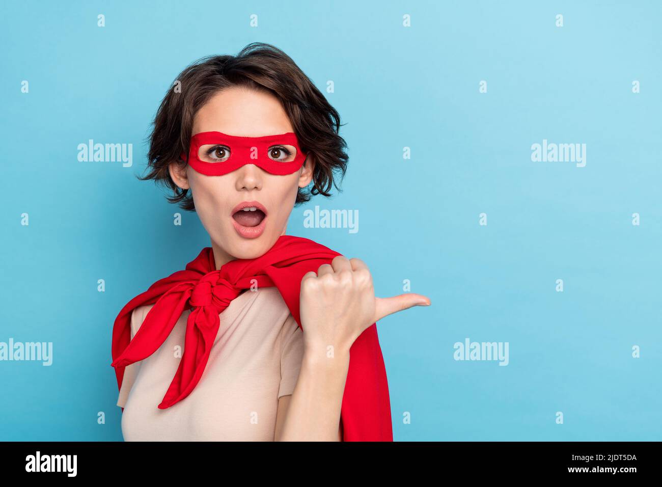 Photo of impressed shocked lady dressed red mantle pointing thumb back ...
