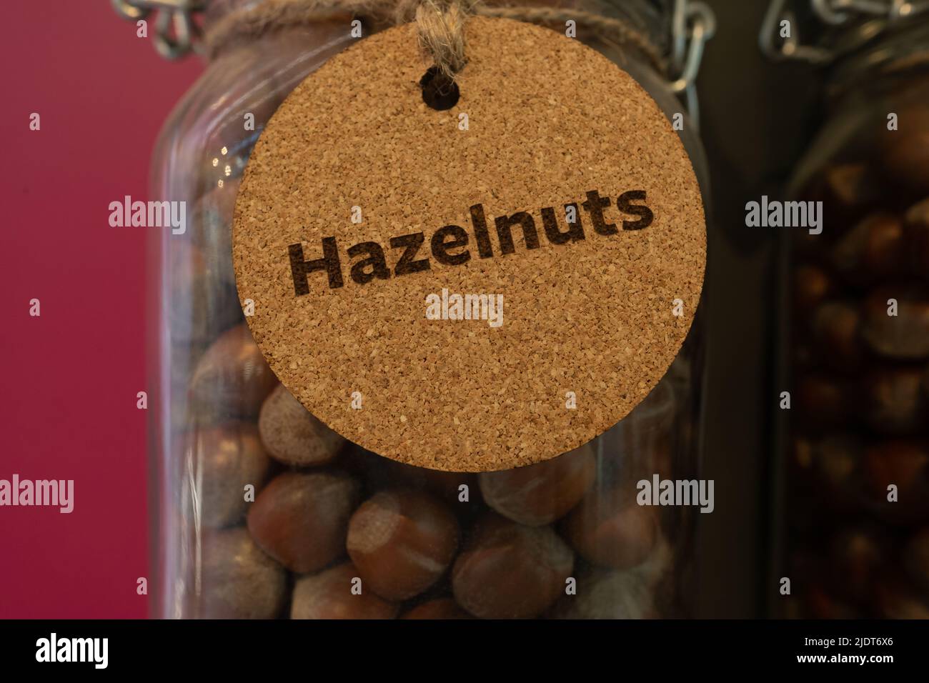 Jar of hazelnuts on display with label Stock Photo - Alamy
