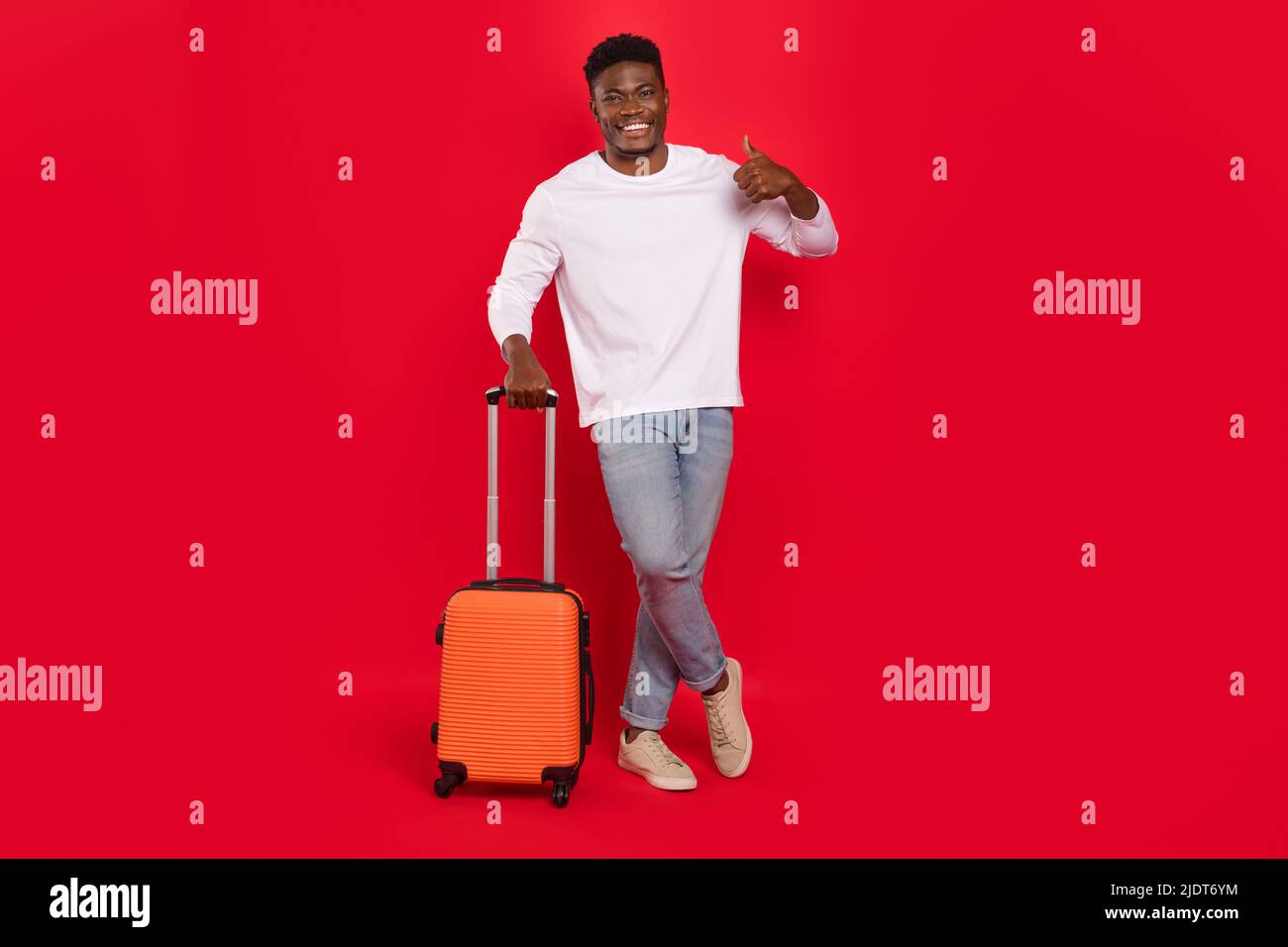 Full length photo of positive person hold suitcase demonstrate thumb up ...