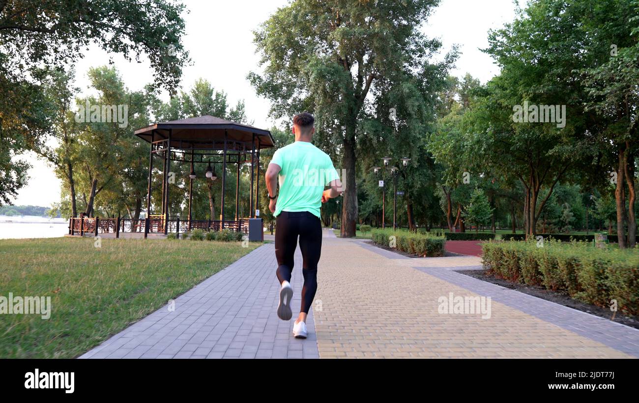 man running in sportswear outdoor back view, sport Stock Photo - Alamy