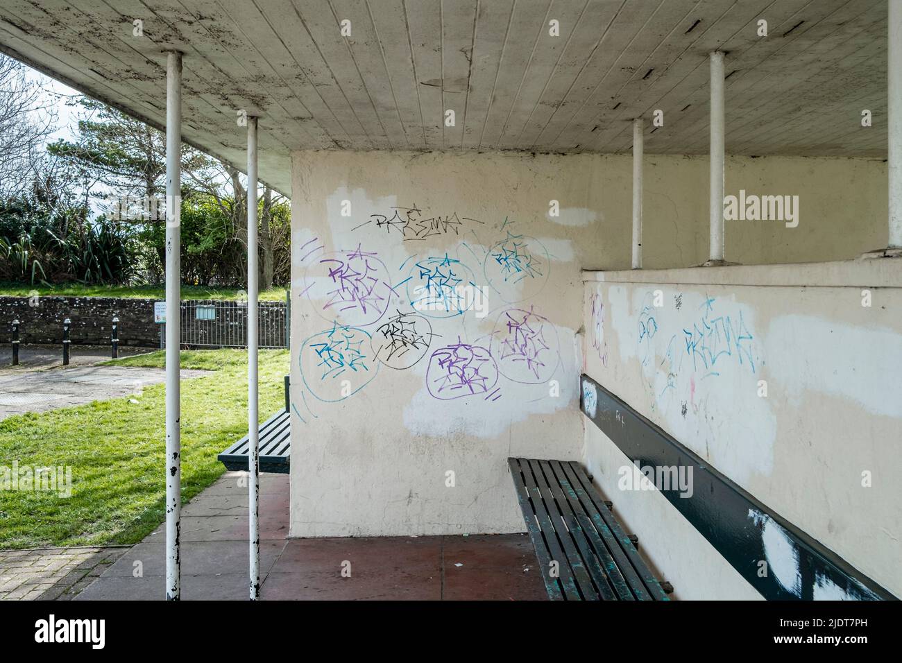 Graffiti tags defacing a wall in a shelter in Newquay in Cornwall in ...