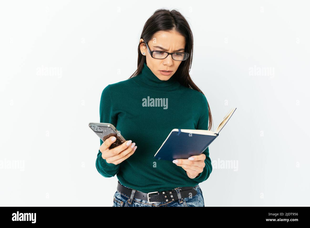 Worried young woman company employee holds smartphone and looks in ...