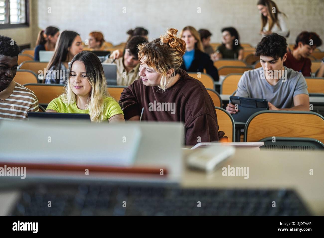 Young students working with tablets inside classroom at school ...