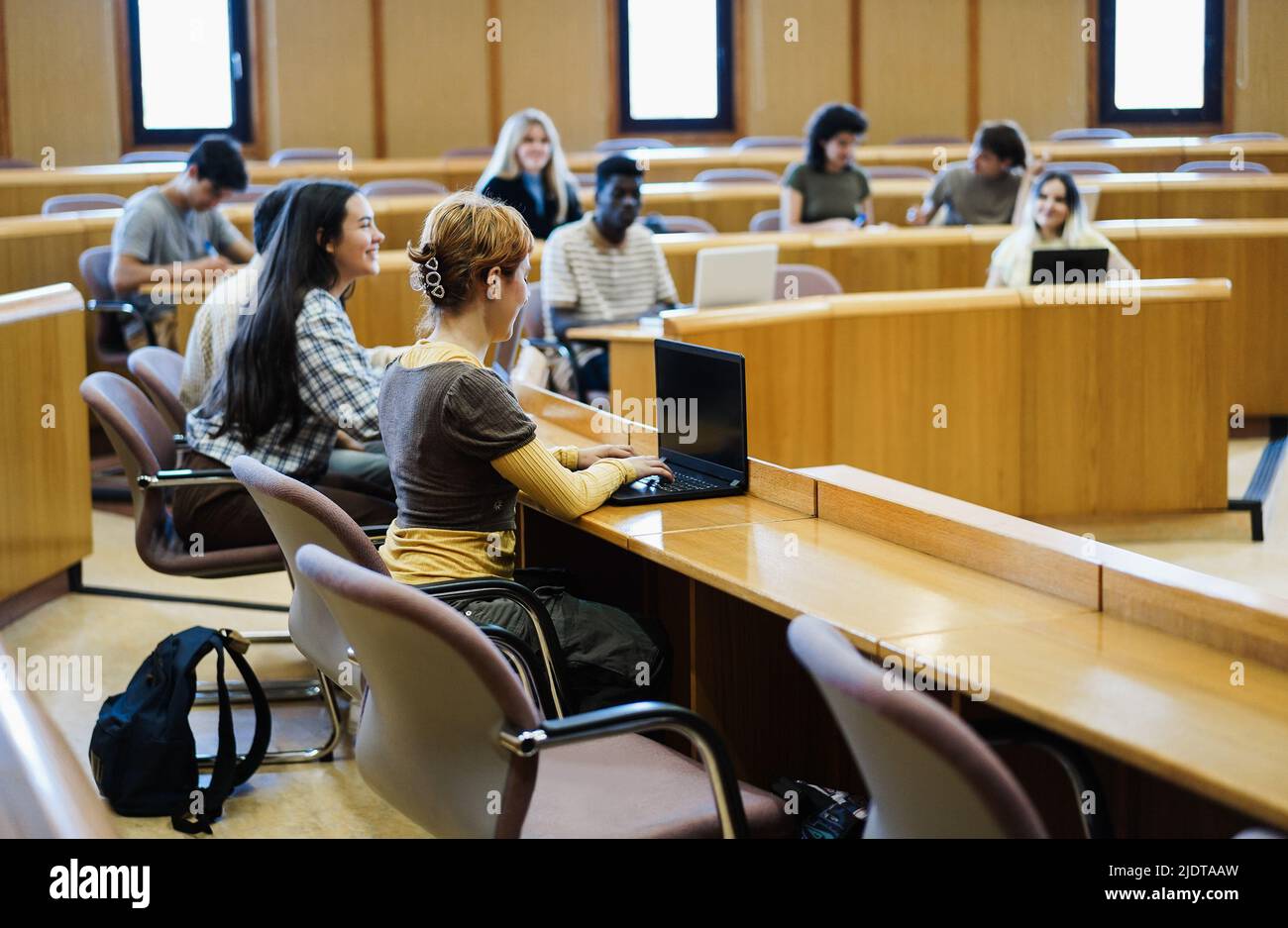 Young students working with laptop computers inside classroom at school ...