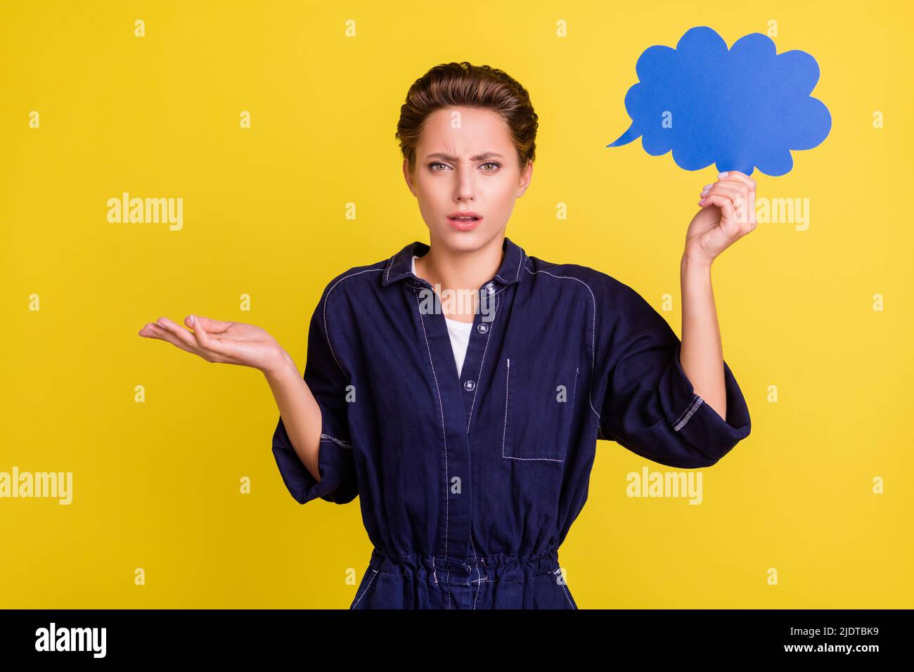 Portrait of attractive confused girl saying comment holding copy space ...