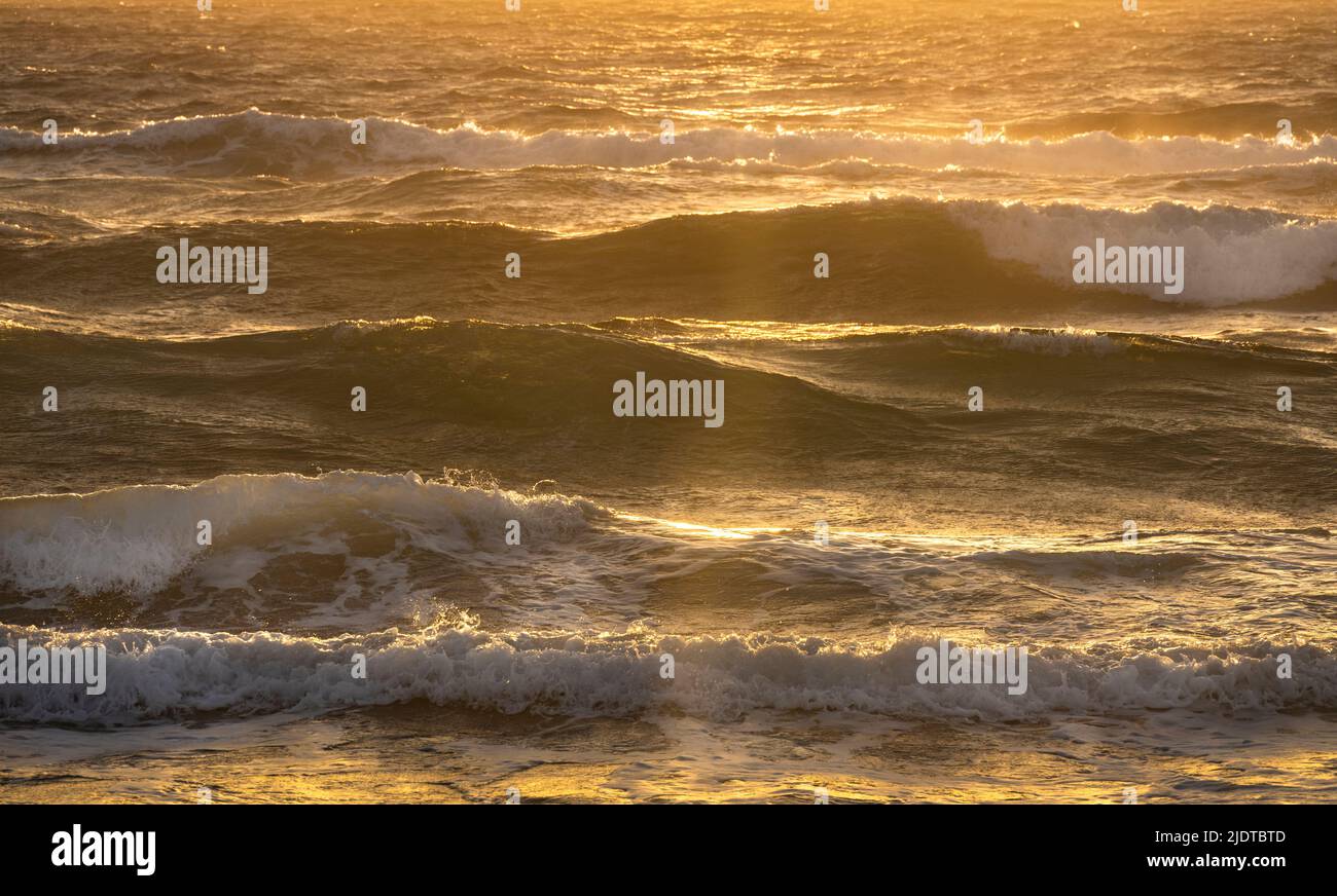 Golden sea sunrise splashing waves hi-res stock photography and images ...