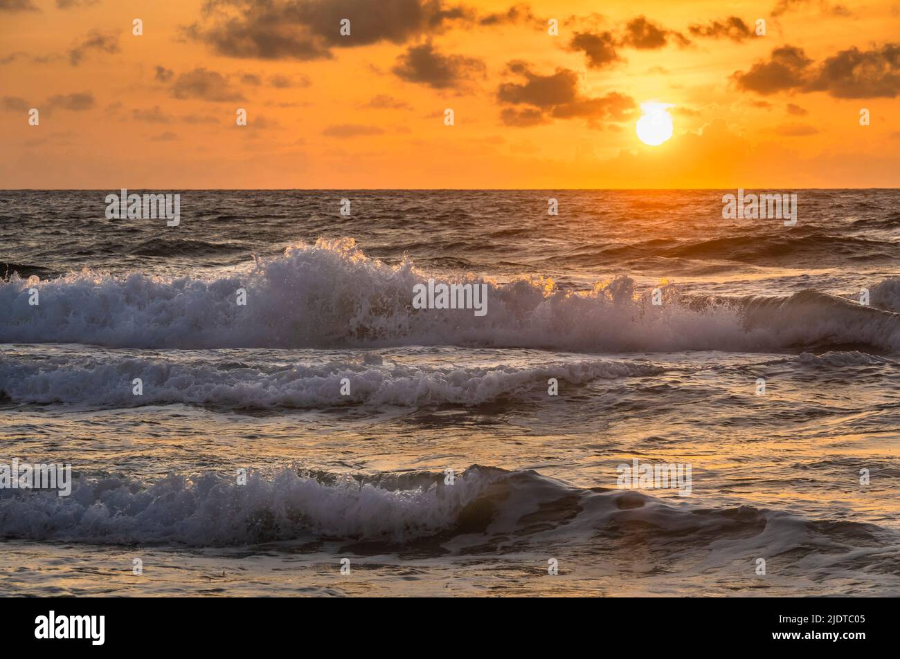 Ocean waves at sunrise Stock Photo - Alamy