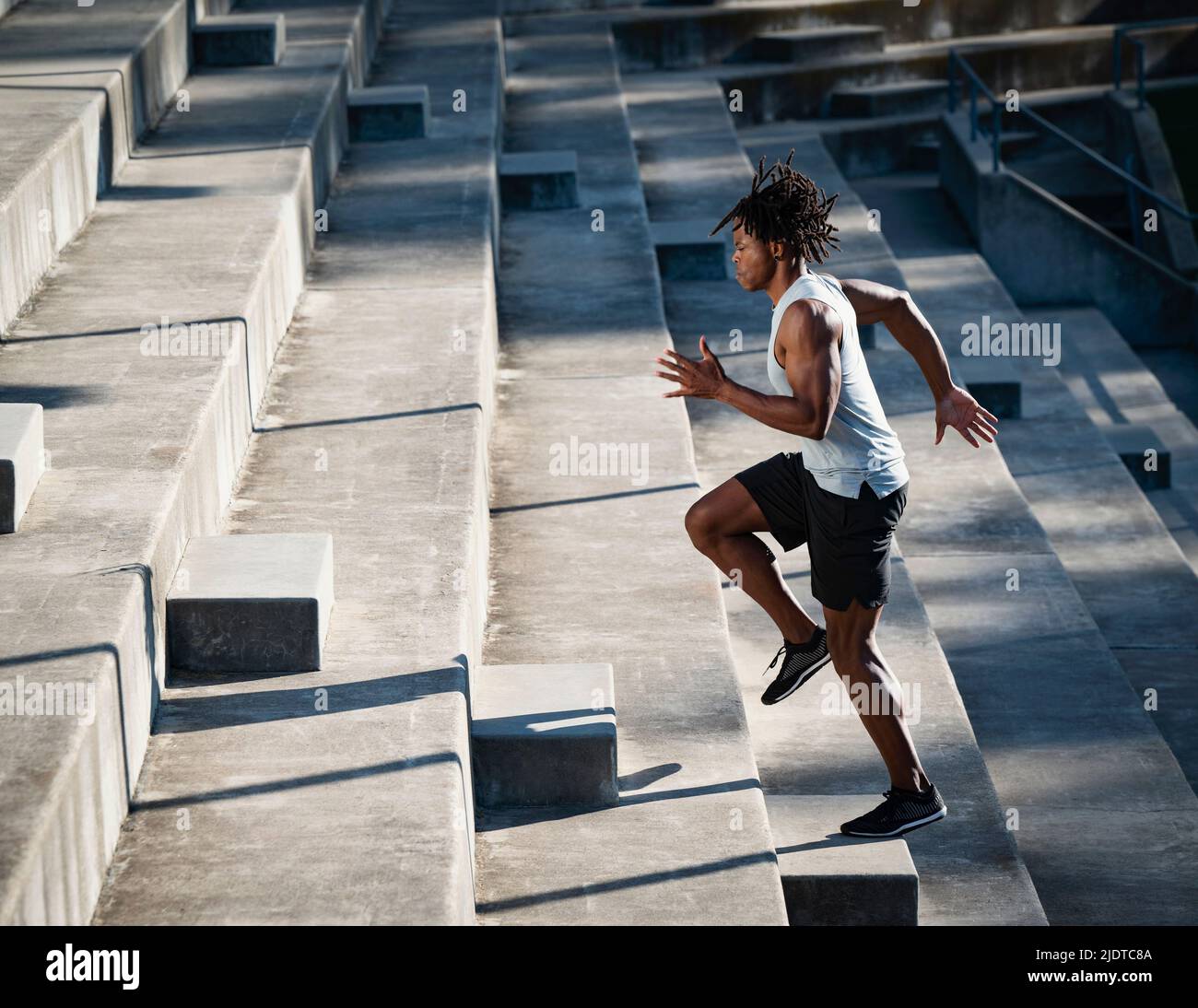 Athletic man running up steps Stock Photo - Alamy