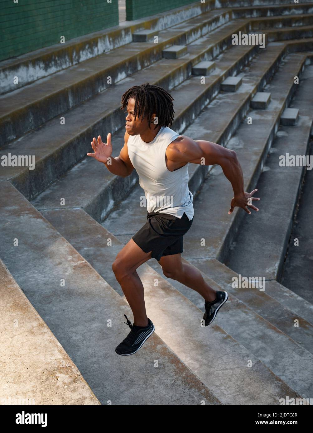 Athletic man running up steps hi-res stock photography and images - Alamy