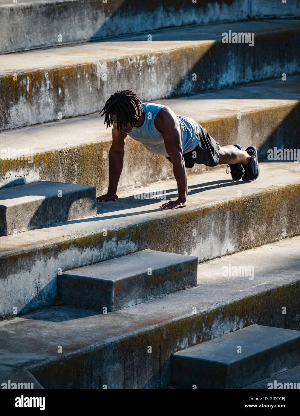 Athletic man doing push-ups on steps Stock Photo - Alamy