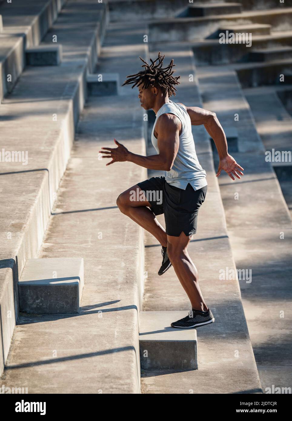 Athletic man running up steps Stock Photo - Alamy