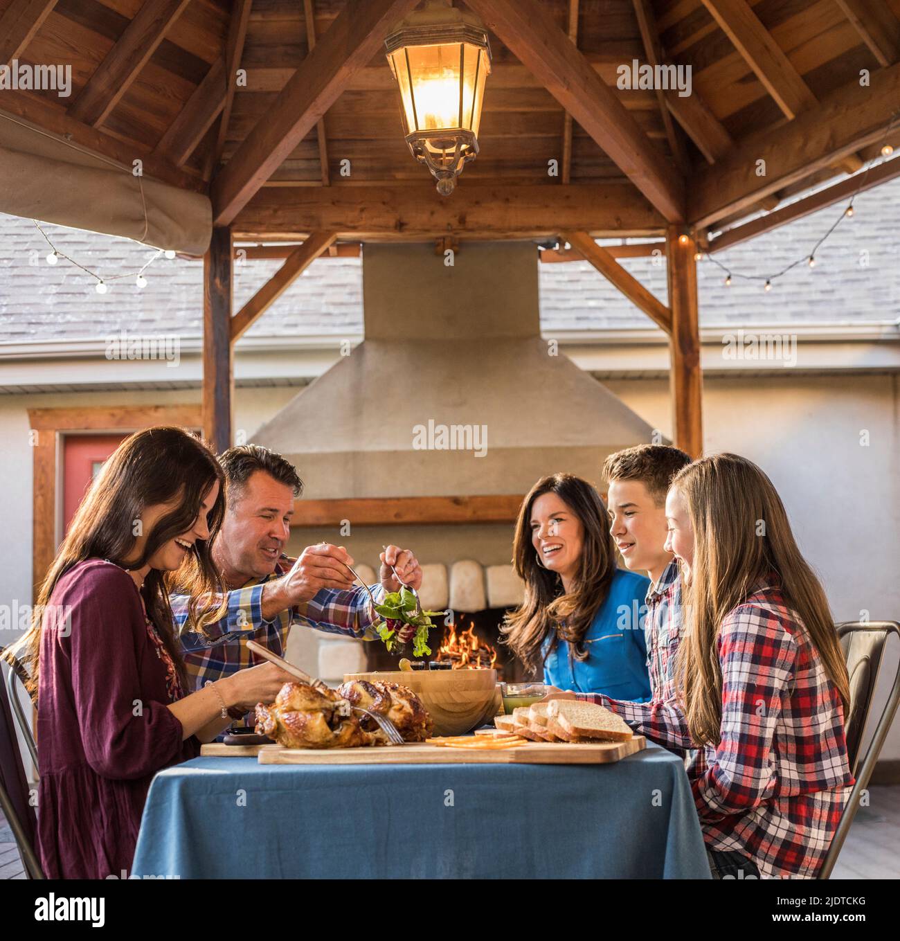 Family enjoying dinner on patio Stock Photo - Alamy