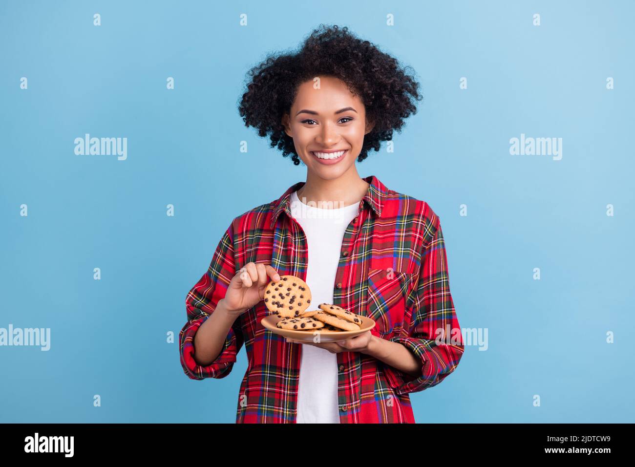 Photo of young african girl happy positive smile hold plate cookies ...
