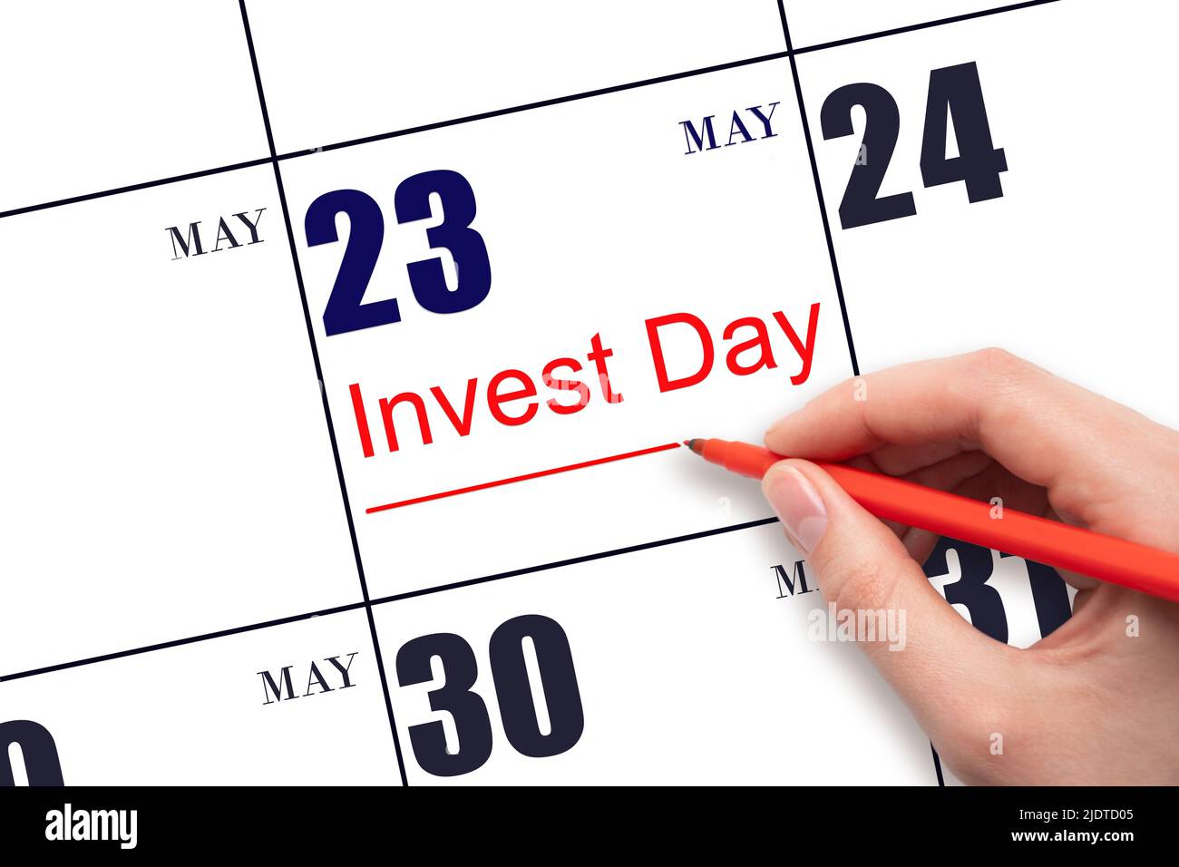 23rd day of May. Hand drawing red line and writing the text Invest Day ...