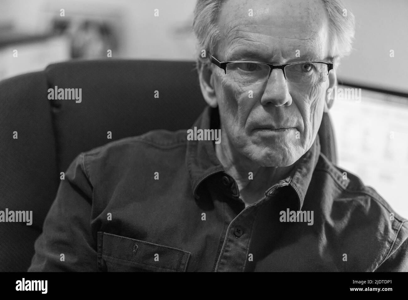 Portrait of senior man with laptop in background, black and white Stock ...