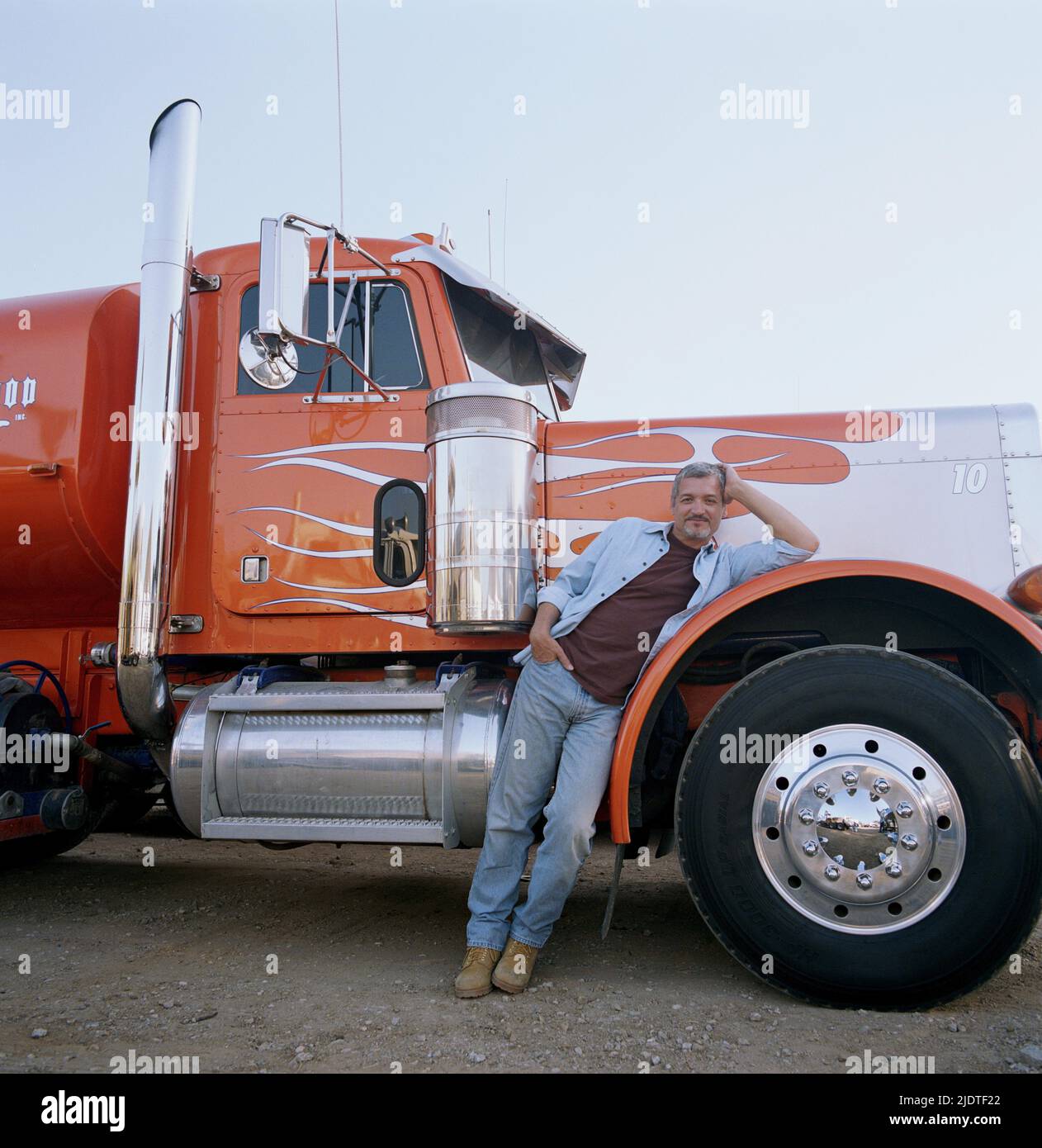 Truck driver leaning on his vehicle Stock Photo - Alamy