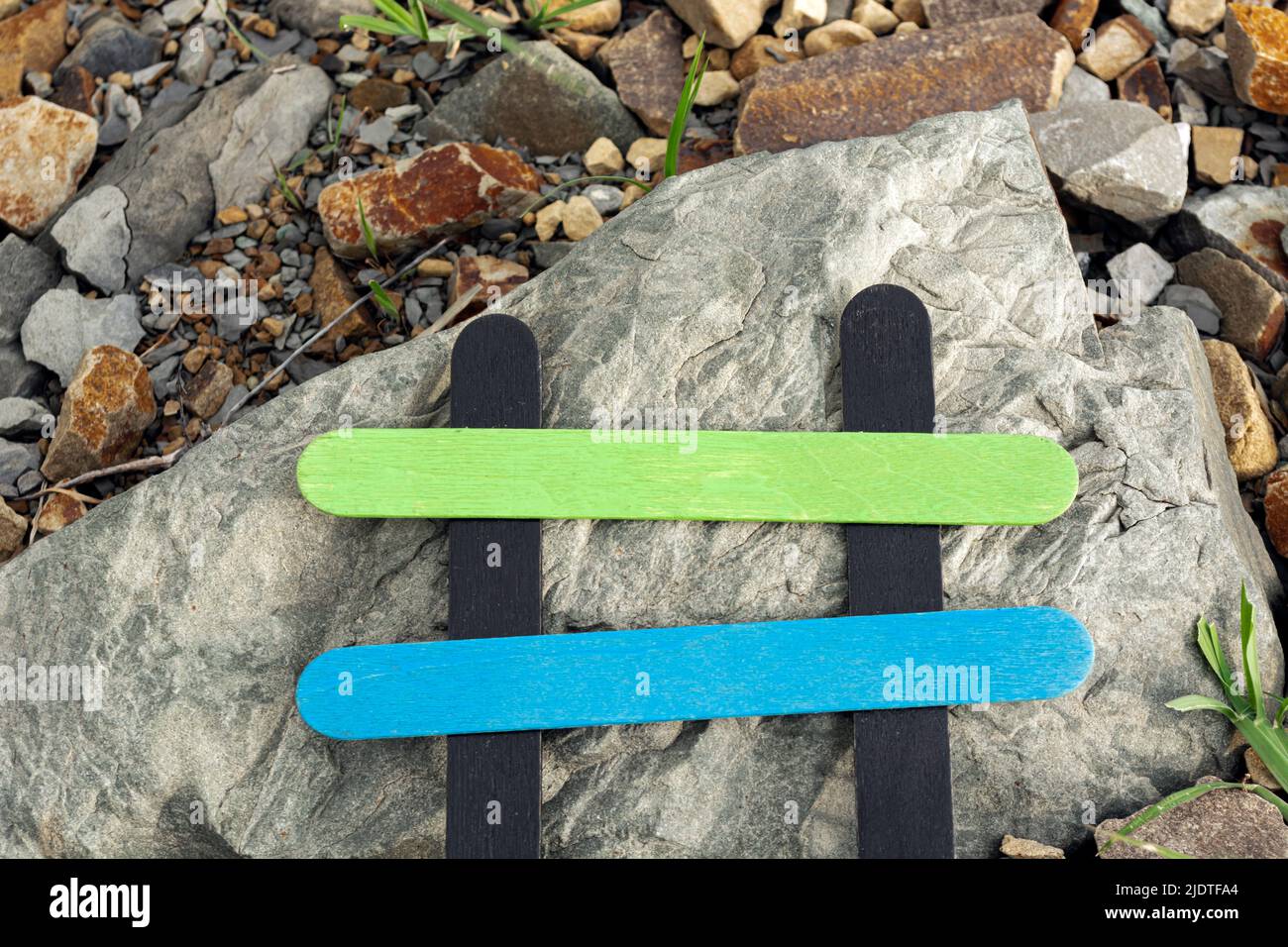 Colorful wooden stick on stone beach background. Copy space. Directly ...