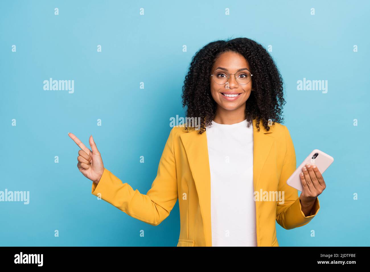 Photo of young black woman happy positive smile hold mobile point ...