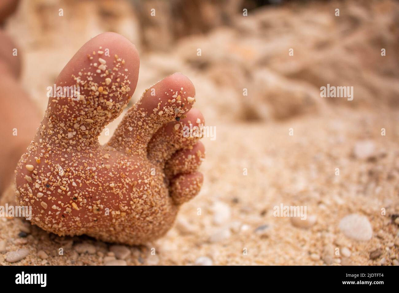 Close-up of the sole of a foot and toes on yellow sand in Turkey Stock ...