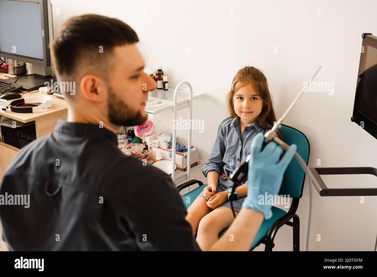 Doctor otolaryngologist with rhinoscope for endoscopy. Child ...