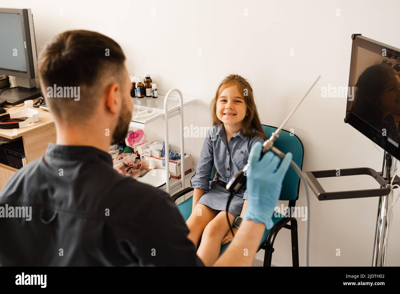 Doctor otolaryngologist with rhinoscope for endoscopy. Child ...