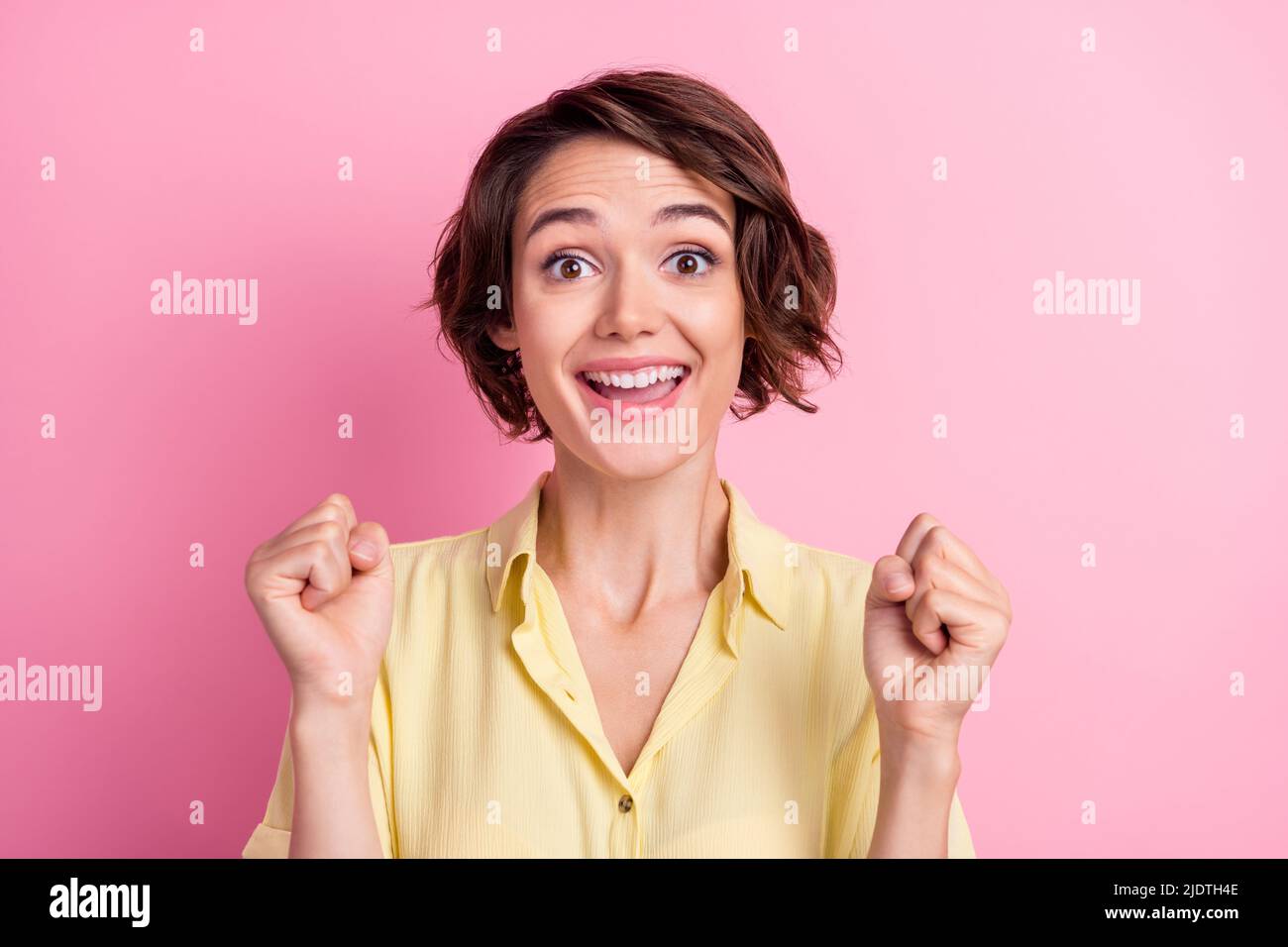 Photo of hooray young brunette lady hands fists wear yellow t-shirt ...