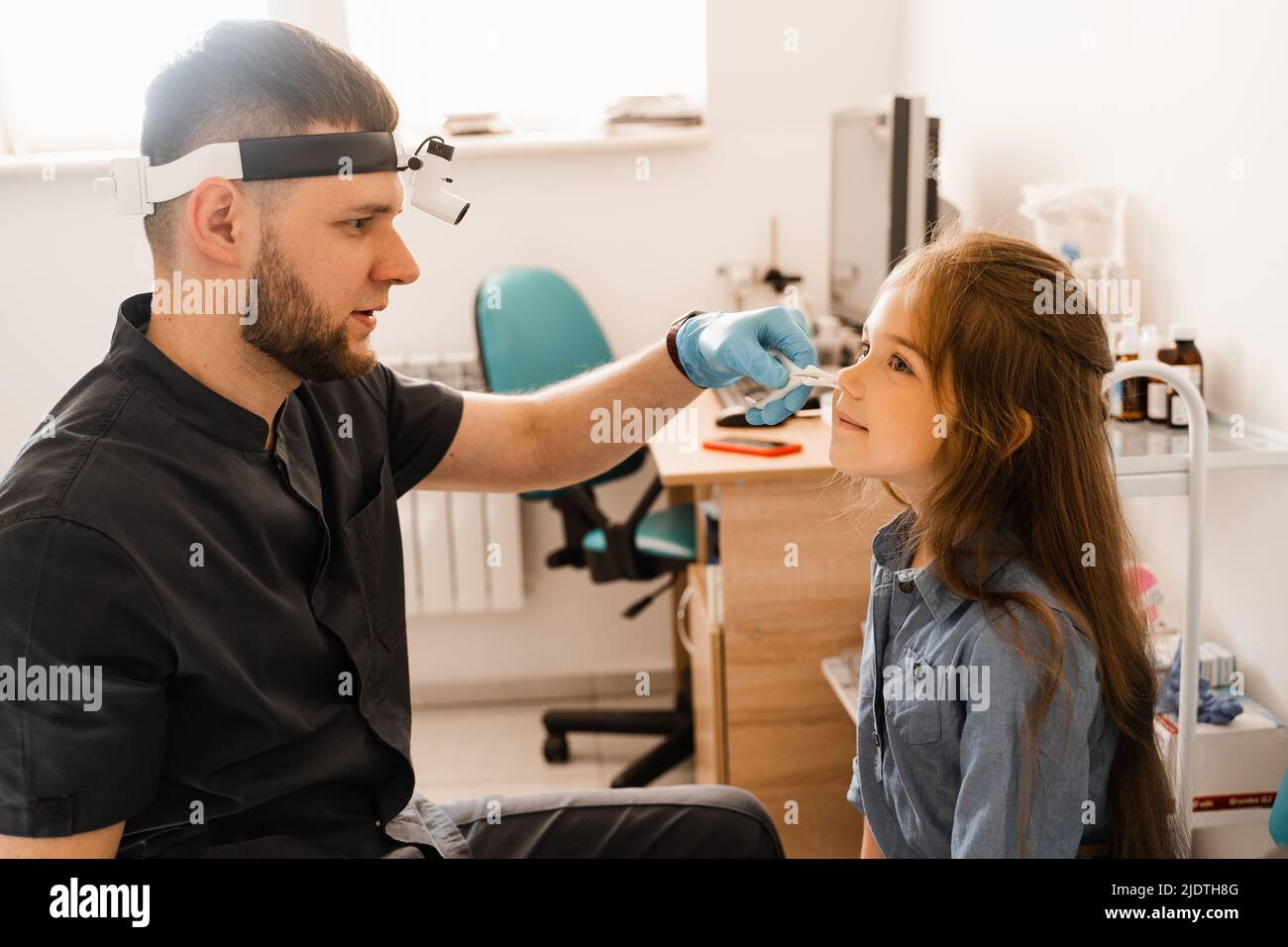 Rhinoscopy of child nose. Consultation with doctor. Children otolaryngologist examines child ...