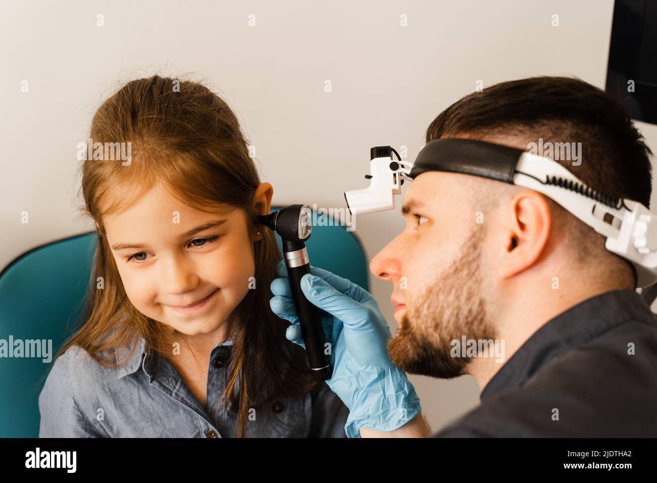 Otoscopy of child ears with otoscope. ENT doctor. Consultation with ...