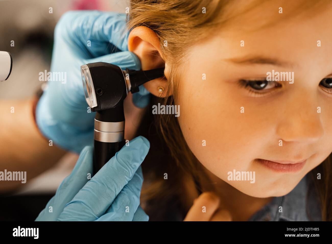 Close-up examination of childs ear with otoscope. Otoscopy. Visit to ...