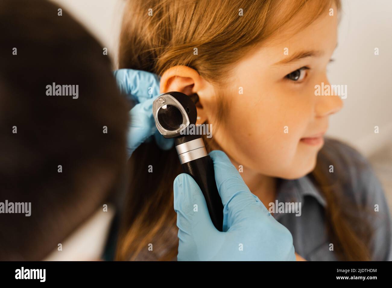 Close-up examination of childs ear with otoscope. Otoscopy. Visit to ...